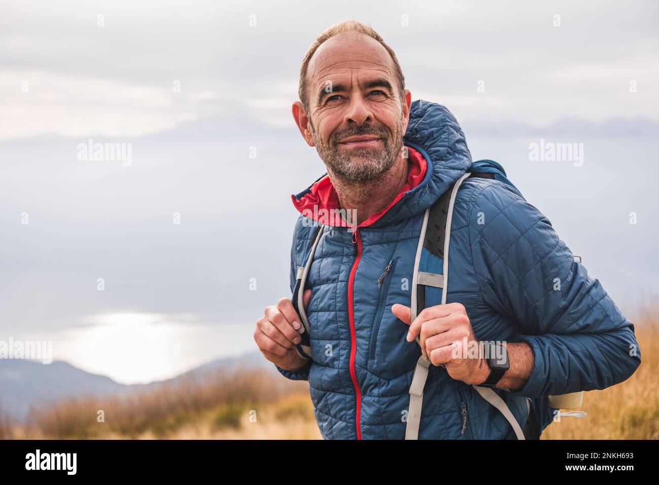 Smiling man standing backpack hi-res stock photography and images - Alamy