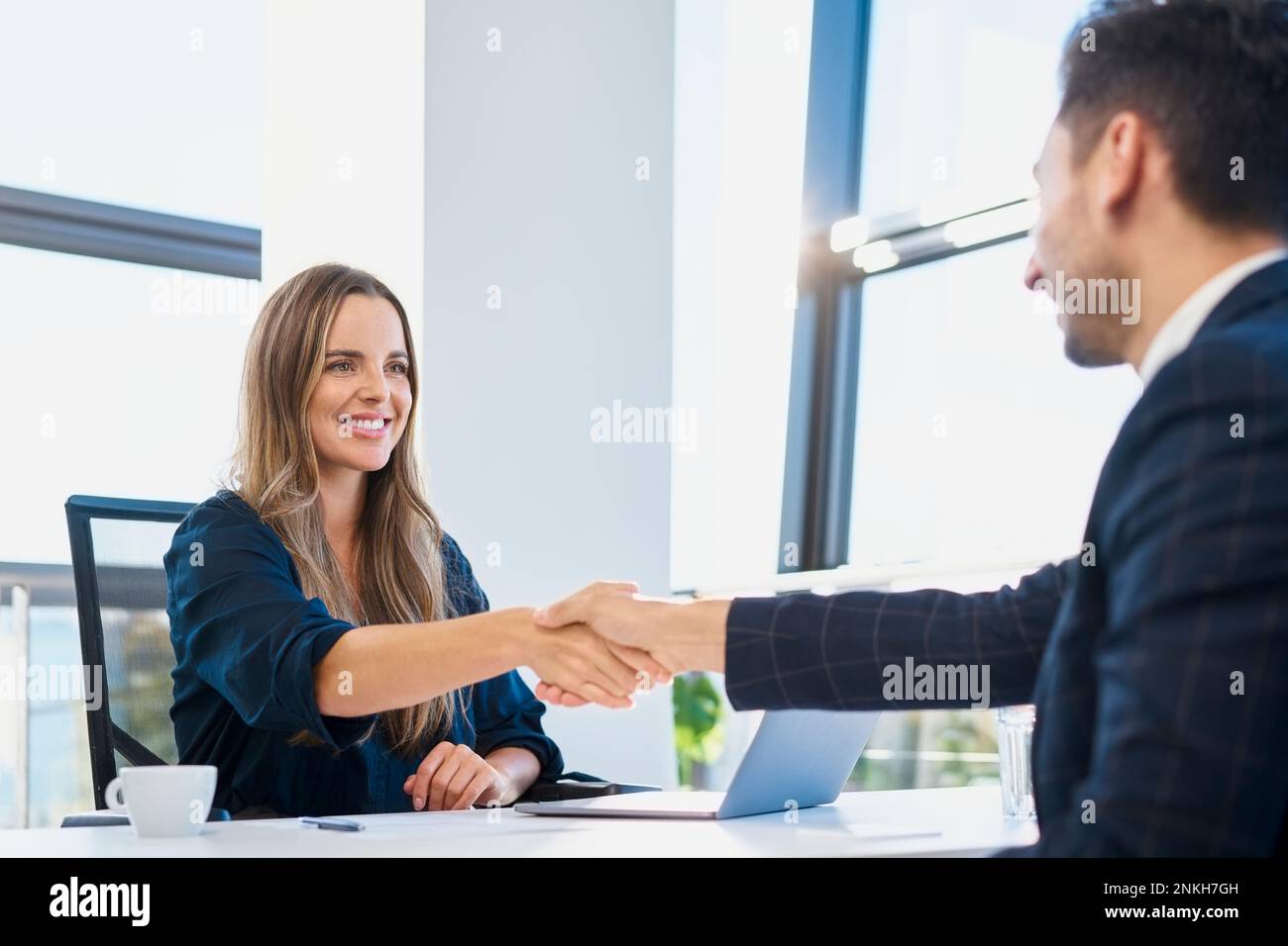 Happy recruiter doing handshake with candidate after job interview at ...