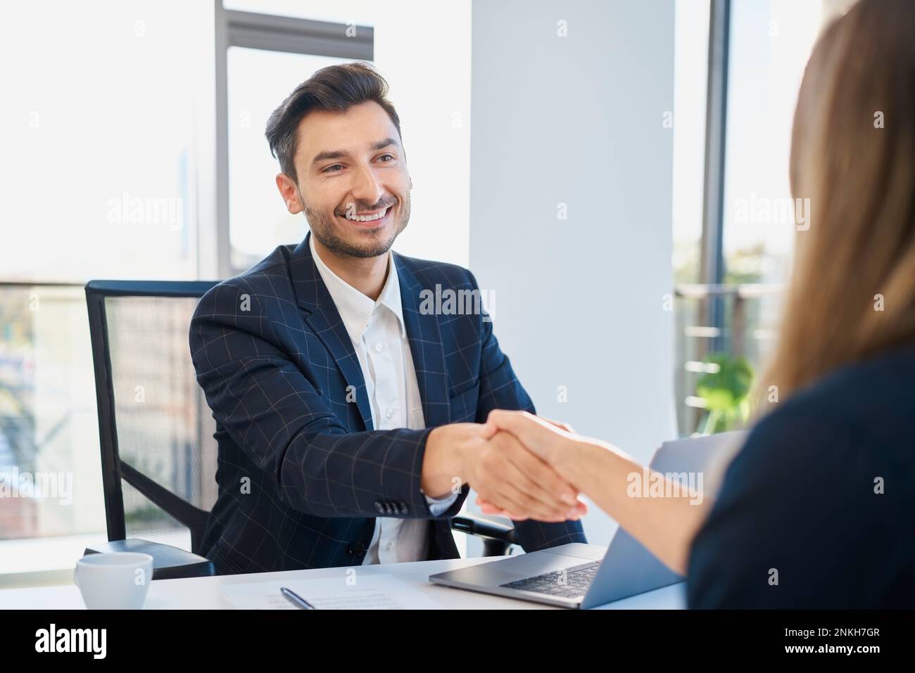Happy recruiter shaking hand with candidate after interview at office ...