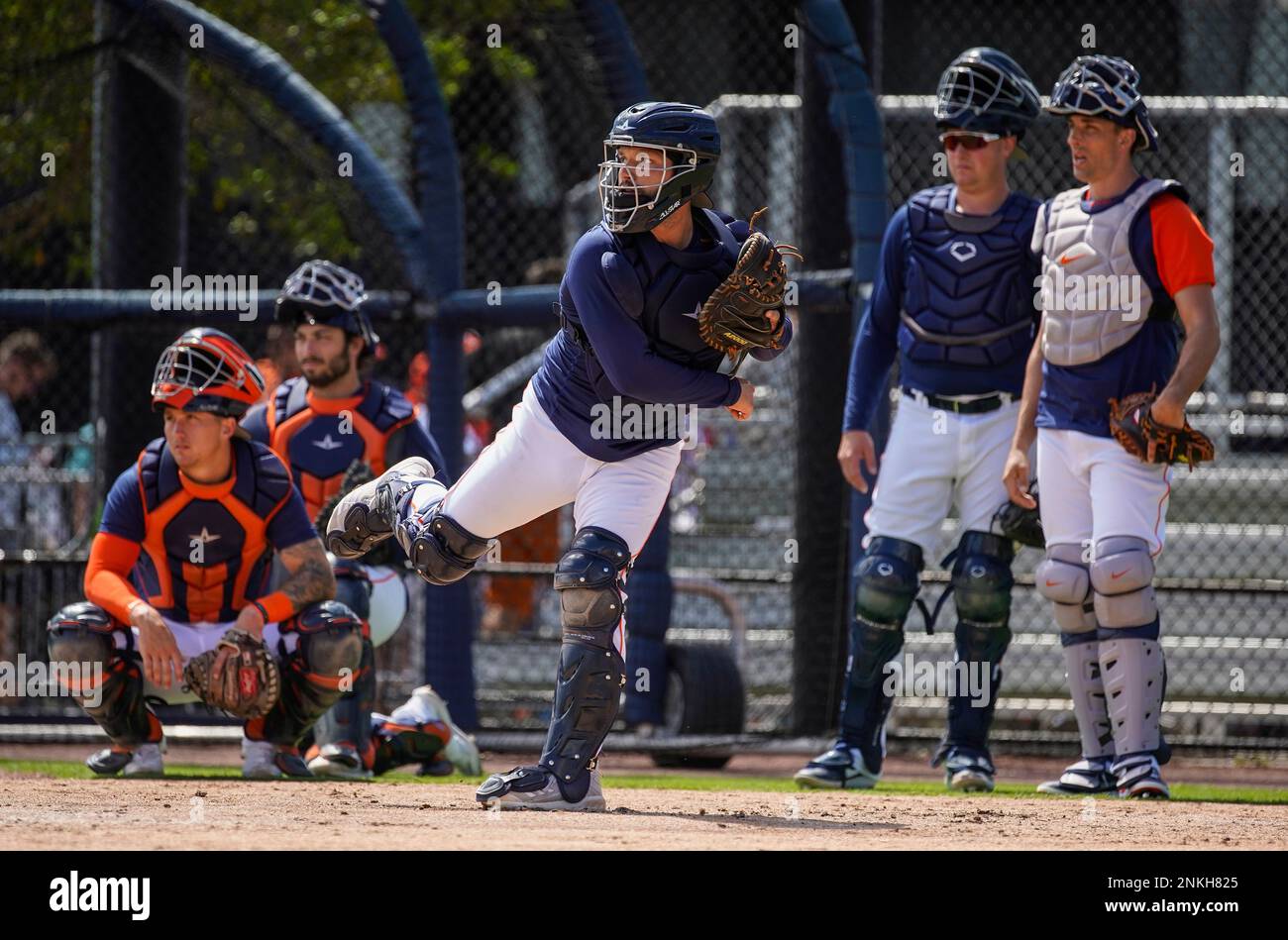 Houston Astros catcher Cesar Salazar, center, throws the ball as other ...