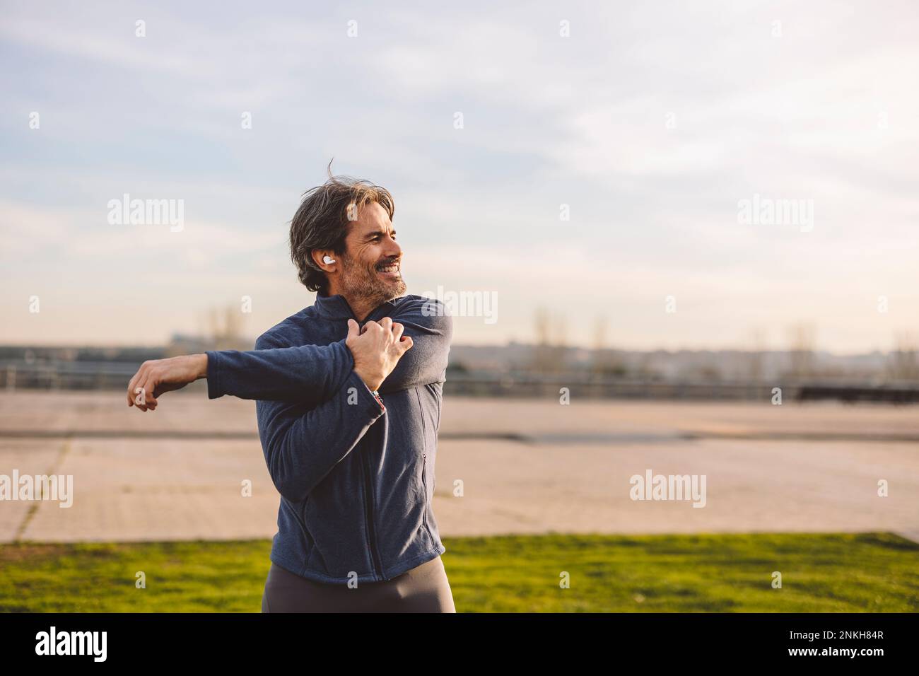 Man stretching in park hi-res stock photography and images - Alamy