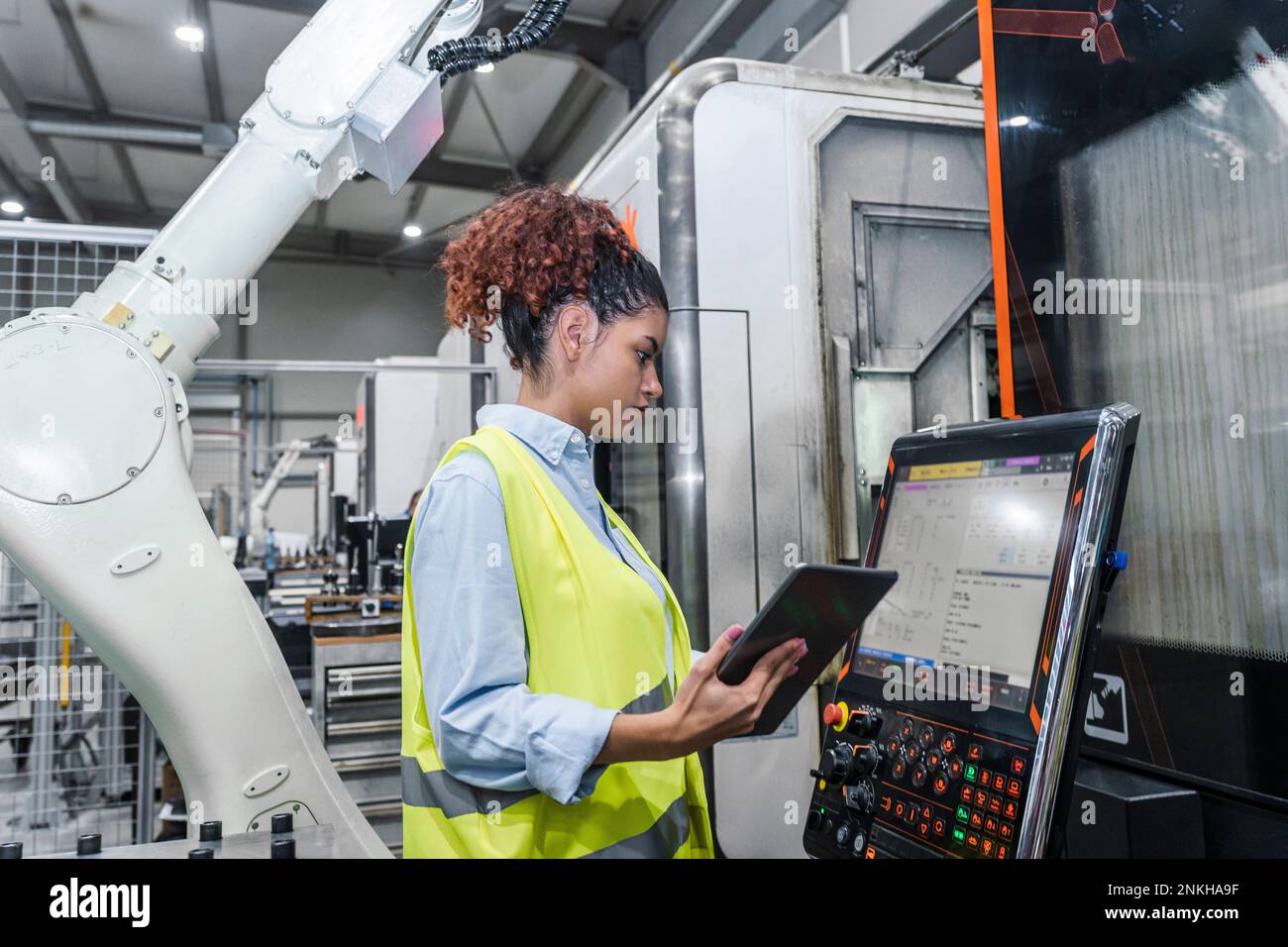 Young engineer operating machine in industry Stock Photo - Alamy