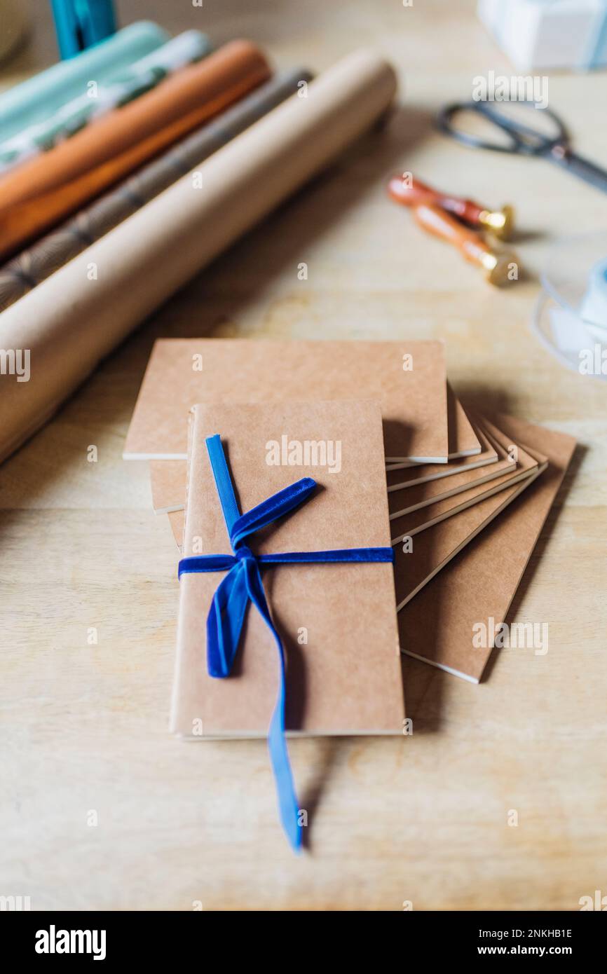 Book tied with blue ribbon at desk Stock Photo - Alamy