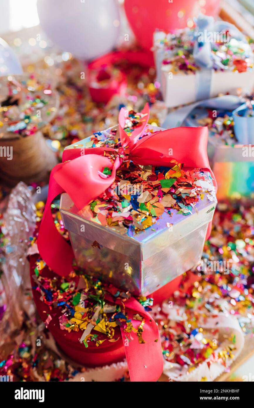 Gift box with confetti on desk Stock Photo - Alamy
