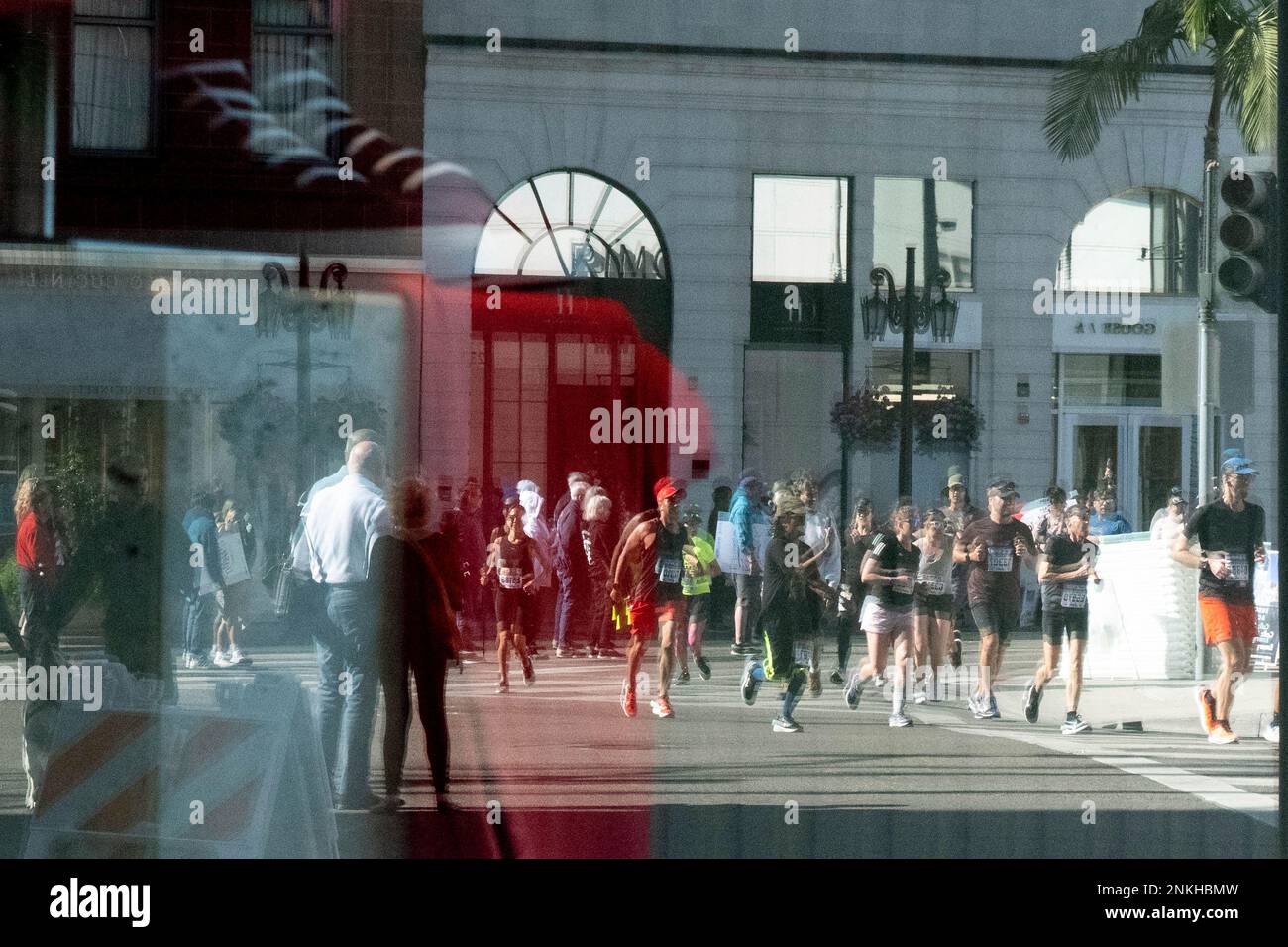 Runners are reflected on store windows along Rodeo Drive in Beverly ...