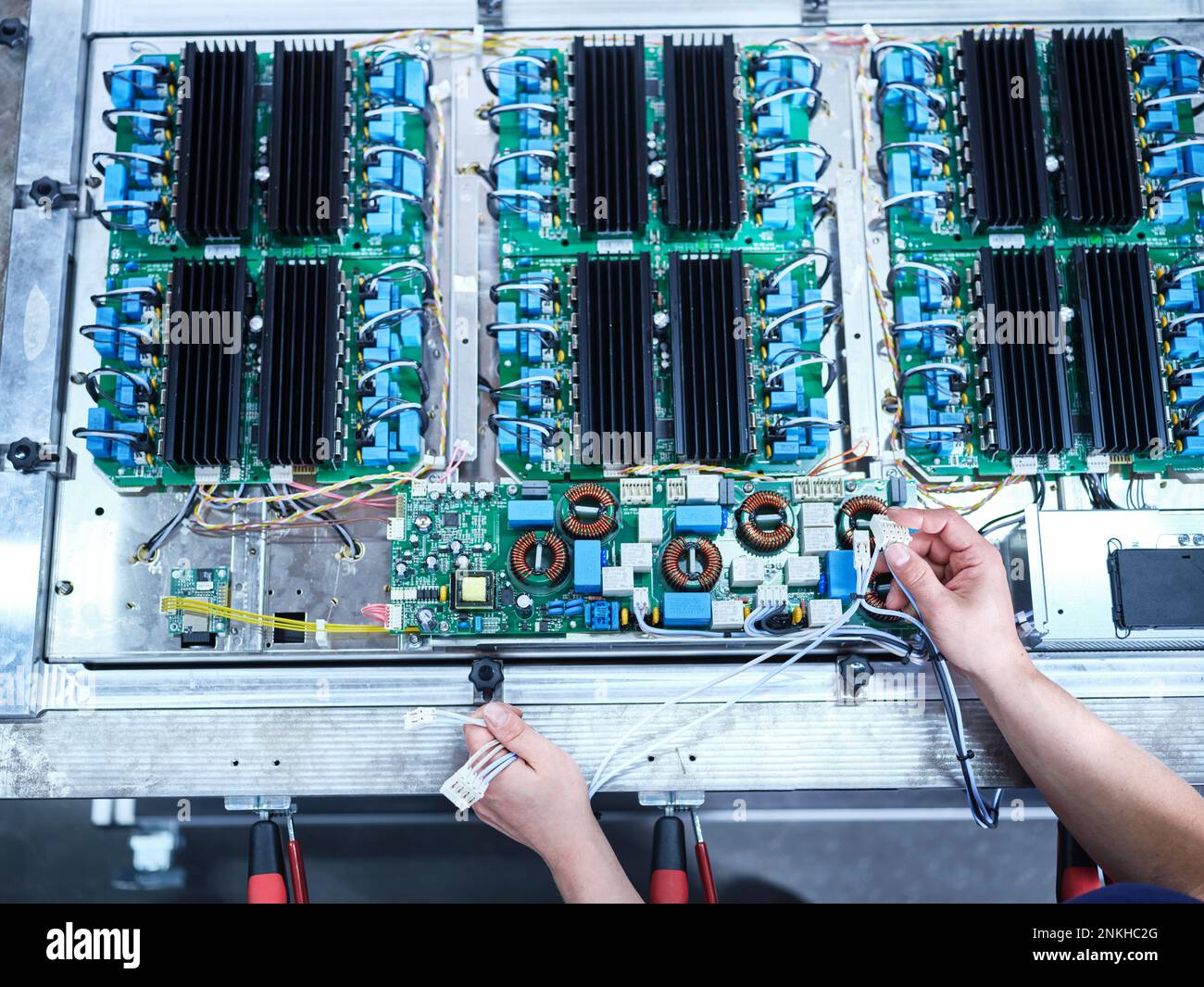 Engineer installing wires on circuit board at factory Stock Photo - Alamy