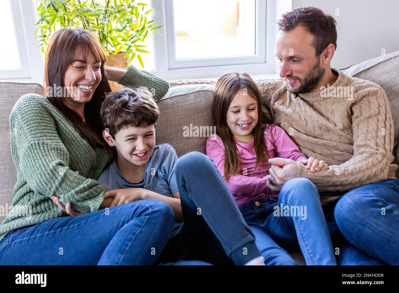 Happy family enjoying together in living room at home Stock Photo - Alamy