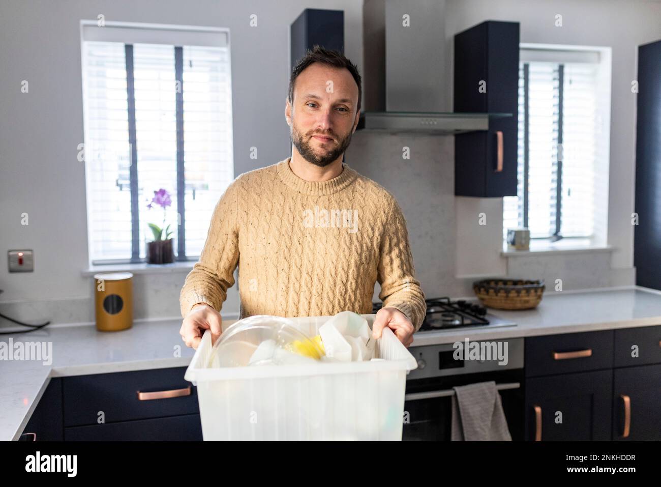 Man recycling plastic at home Stock Photo - Alamy
