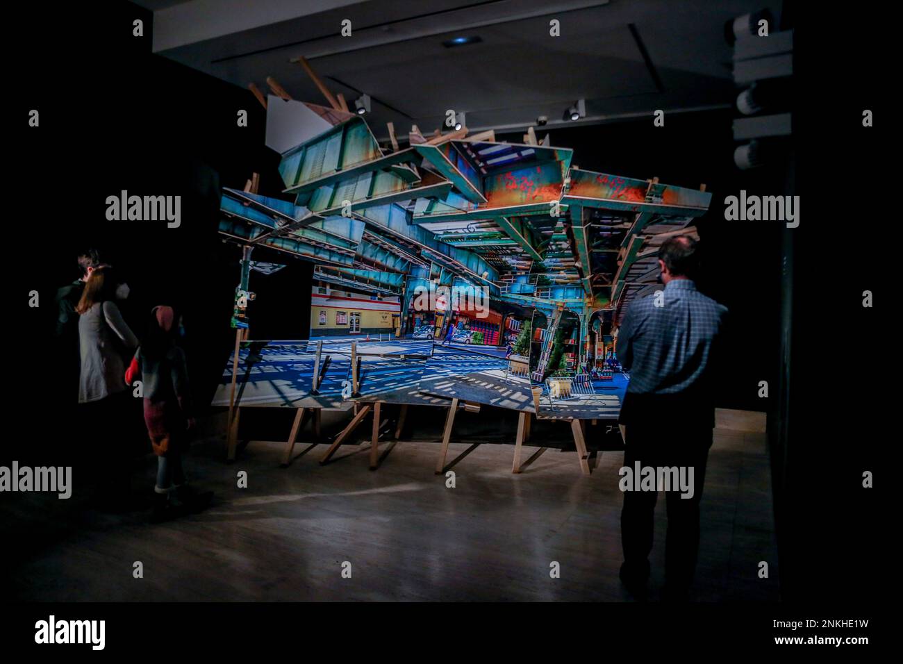 Visitors contemplate the works that are part of the exhibition ...