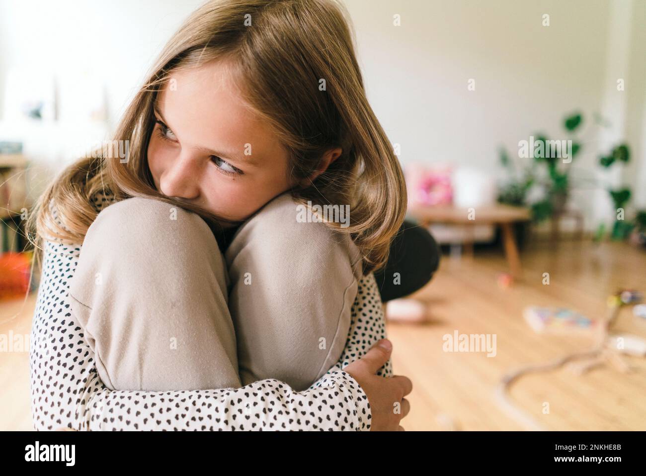 Girl hugging knees hi-res stock photography and images - Alamy