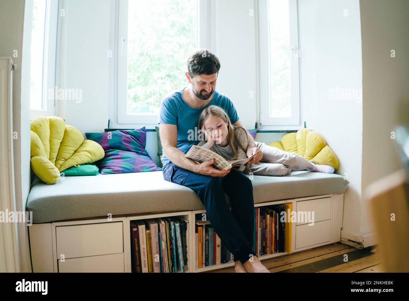 Father telling story to daughter at home Stock Photo - Alamy