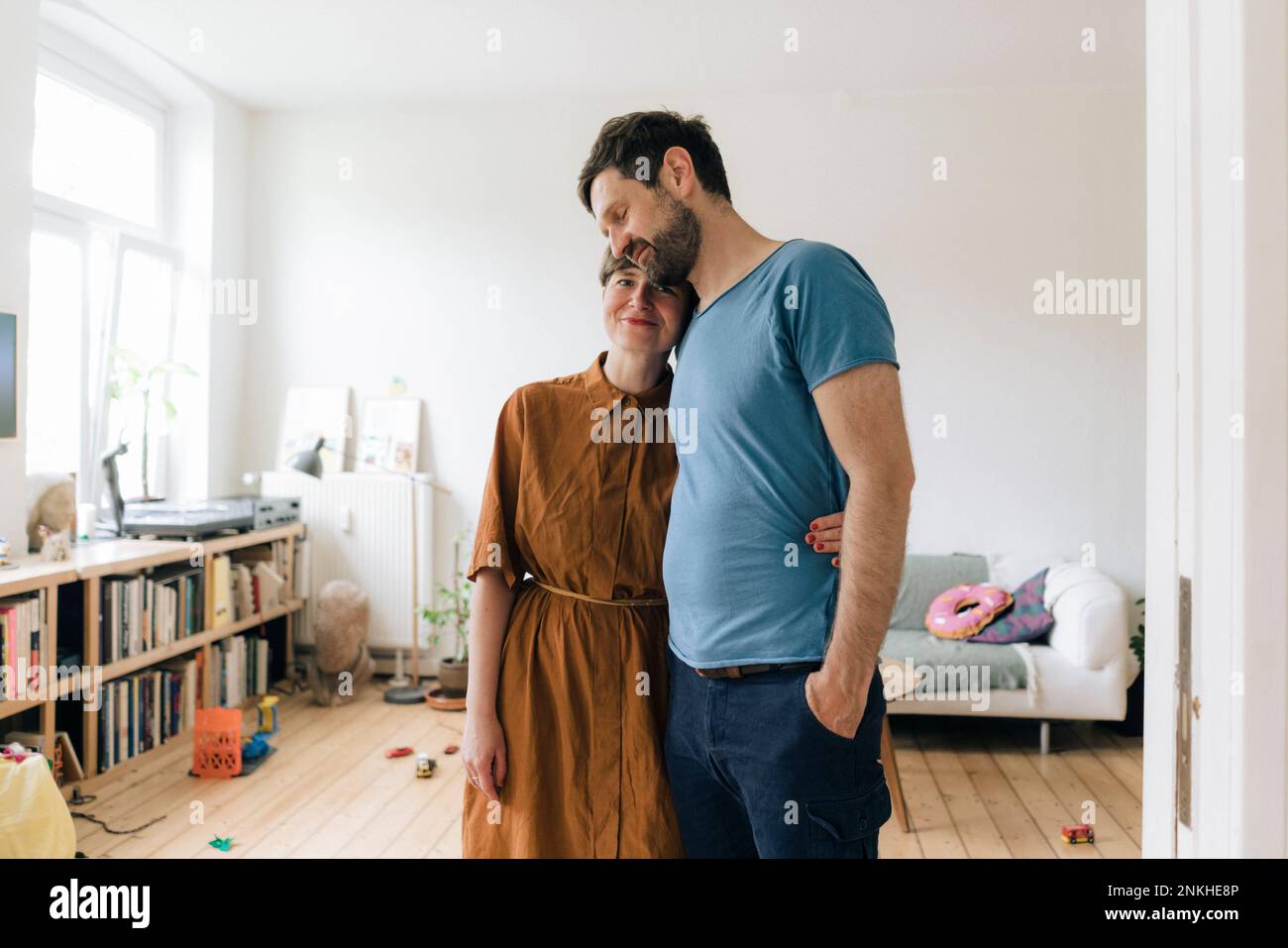 Romantic couple standing in living room at home Stock Photo - Alamy