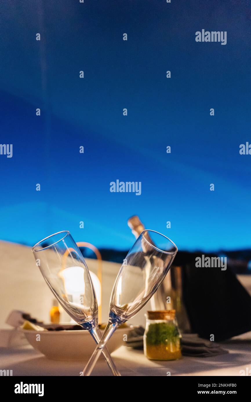 Empty champagne flutes on dining table in dome tent at night Stock ...