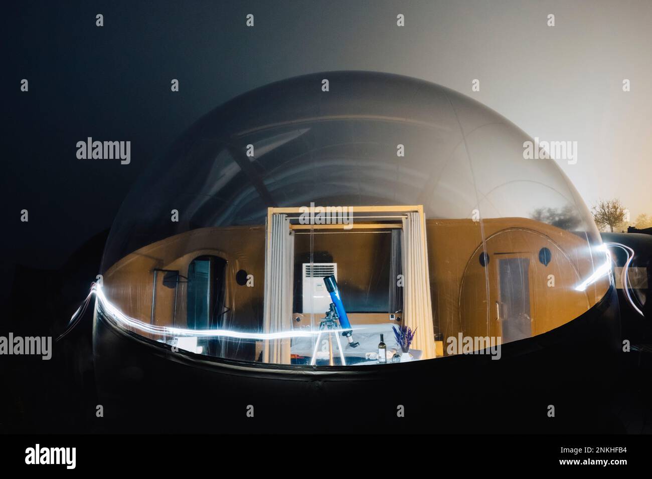 Telescope on tripod inside dome tent with light trails at night Stock ...