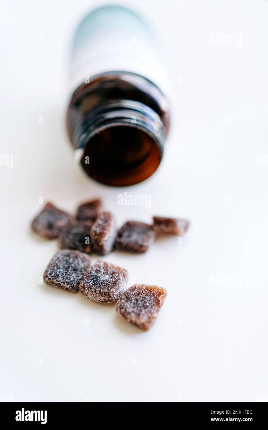Bottle with lozenges against white background Stock Photo - Alamy