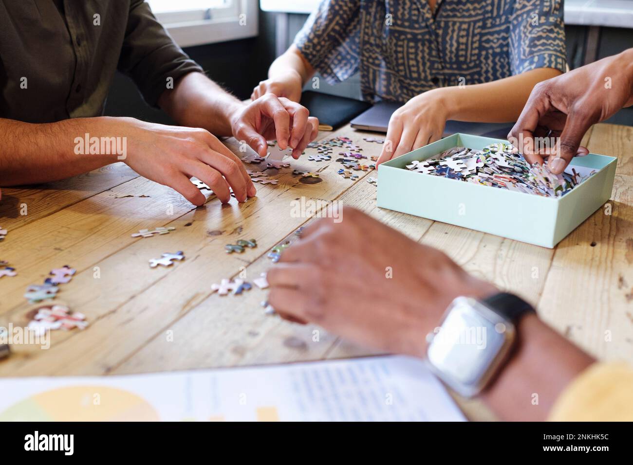 Business colleagues playing puzzle at desk in office Stock Photo - Alamy