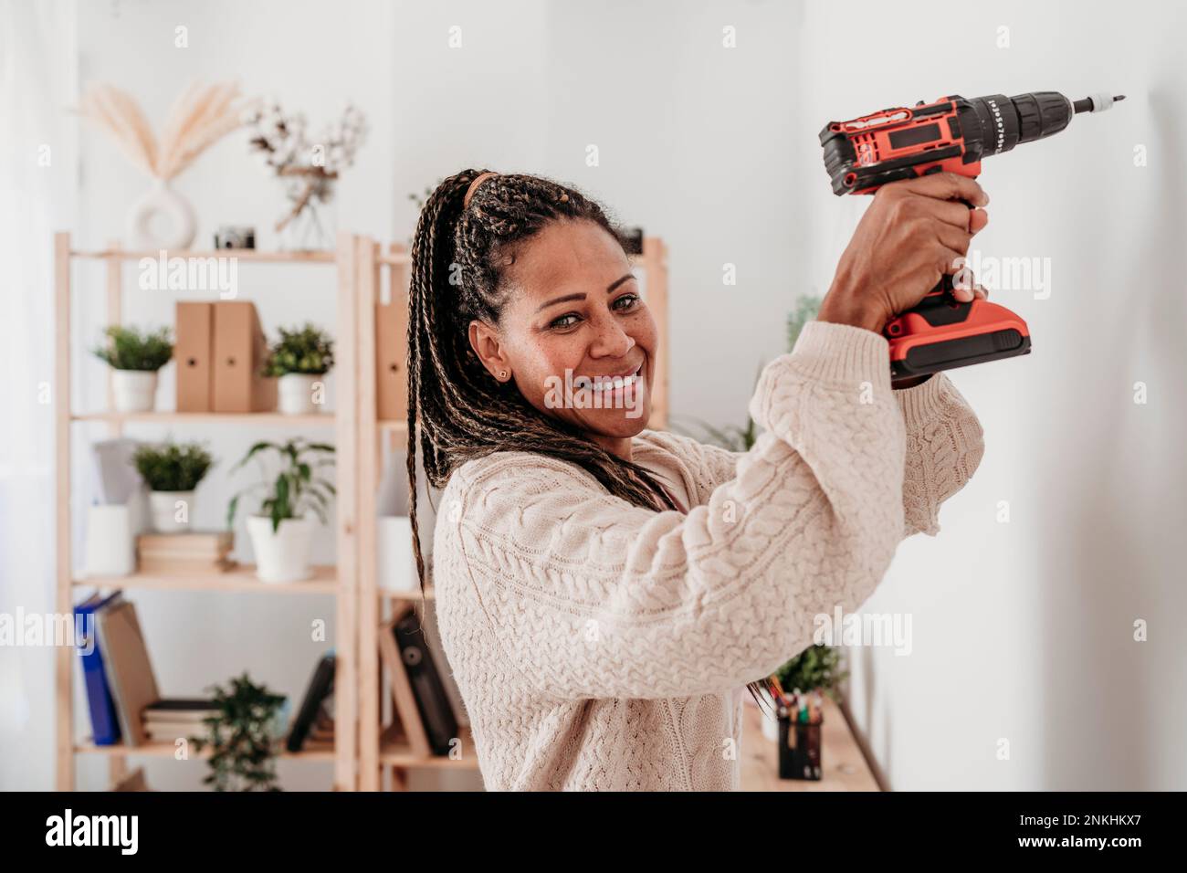 smiling woman with drill machine Stock Photo - Alamy