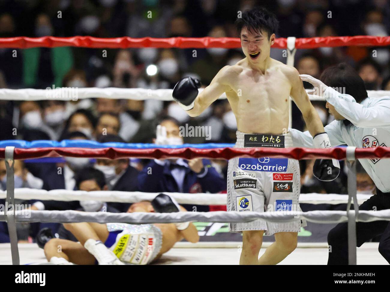 Japanese challenger Kenshiro Teraji (R) reacts after knocking down champion Masamichi Yabuki ...