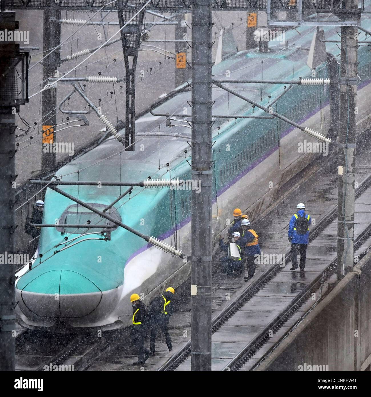 People examine the derailed Shinkansen Bullet train due to the ...