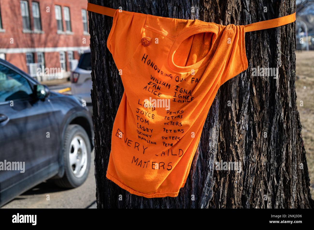 A handwritten Every Child Matters t-shirt with names is tied to a tree ...