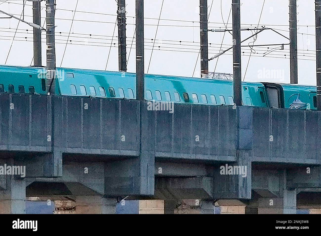 A partially derailed express train sits following an earthquake in ...