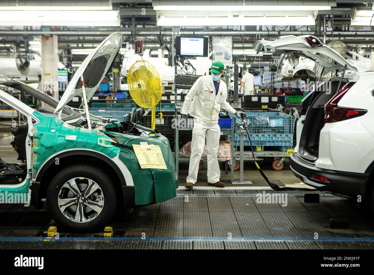 An autoworker stands on the production line for the Honda CRV, at a ...