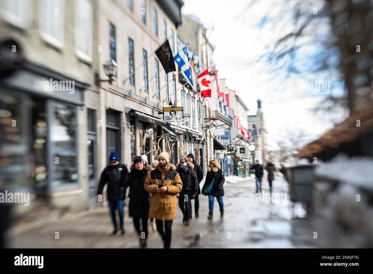 Photo of group of people walking in the winter on a street in the old ...