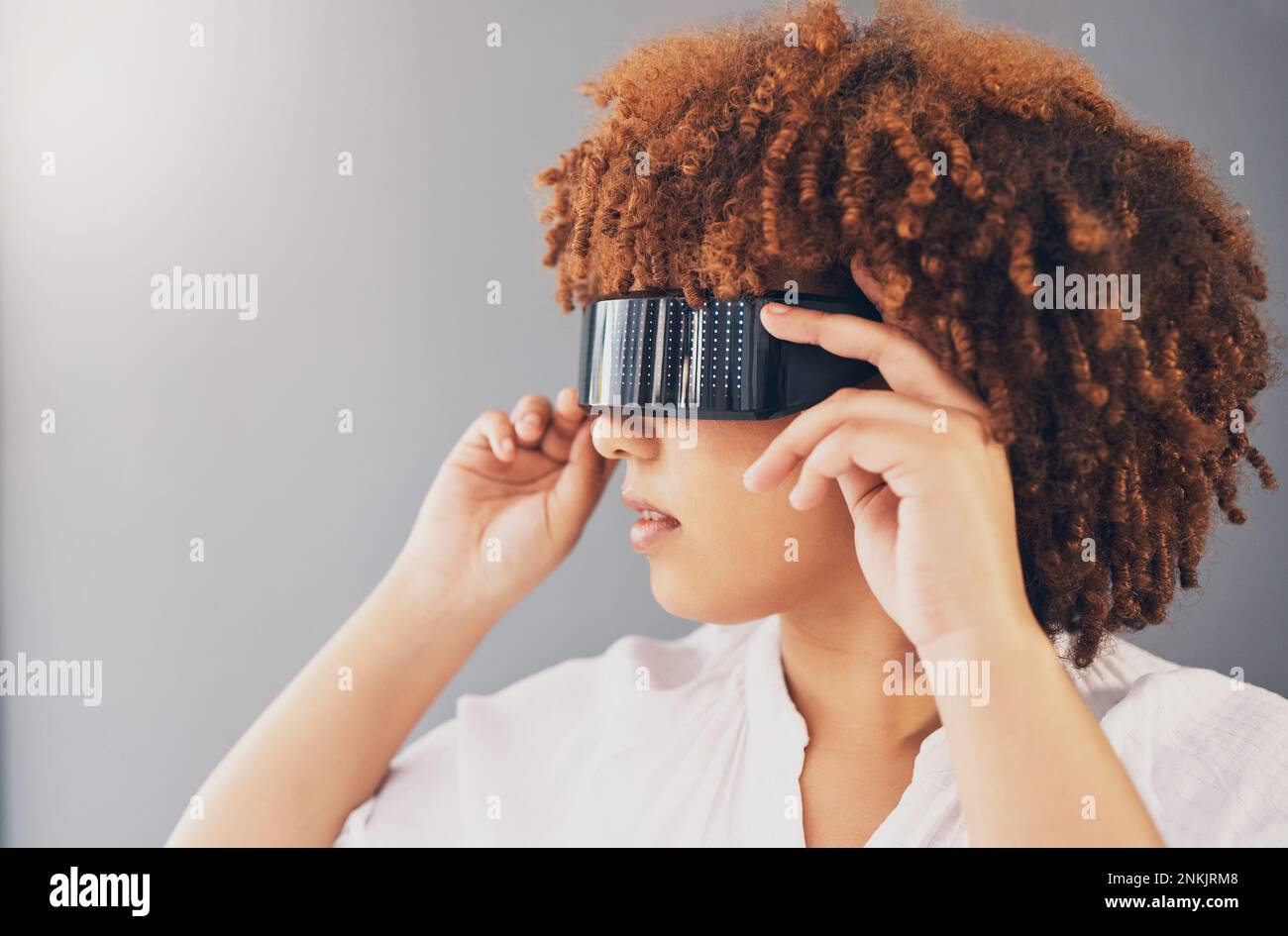 Futuristic, glasses and black woman isolated on a gray background for metaverse, cyberpunk and ...