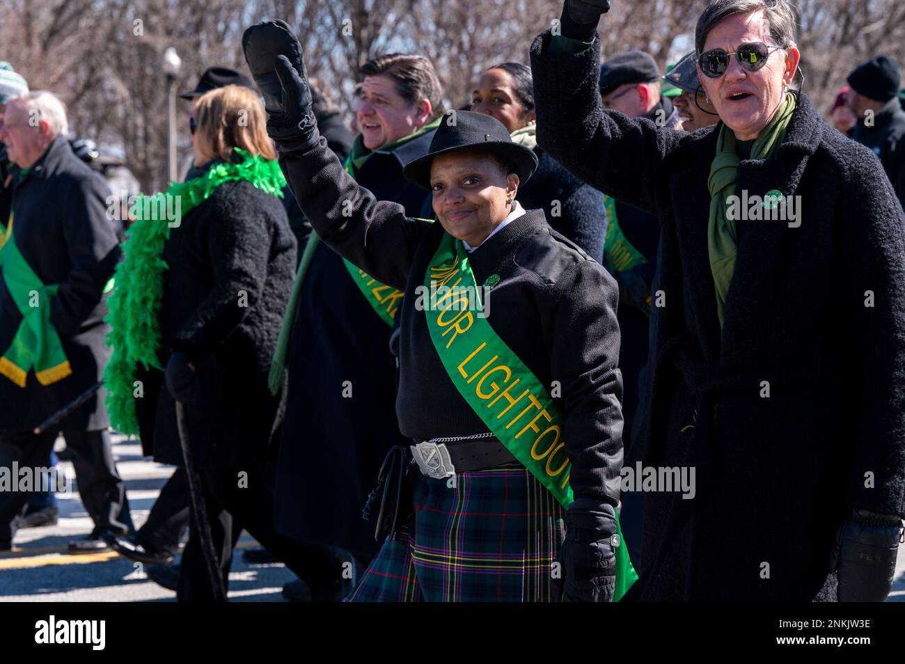 Mayor Lori Lightfoot, center, and wife Amy Eshleman wave to the crowds ...