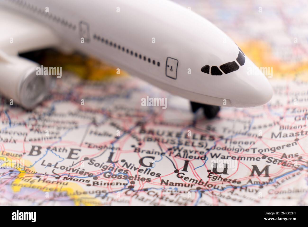 Close up of a miniature passenger plane on a colorful map showing ...