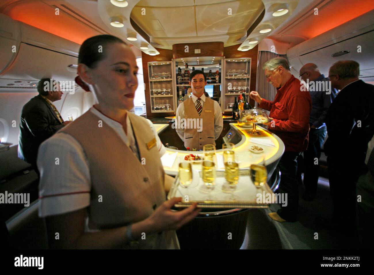 Flight attendant Troy Whittle, center, attends the bar on the upper ...