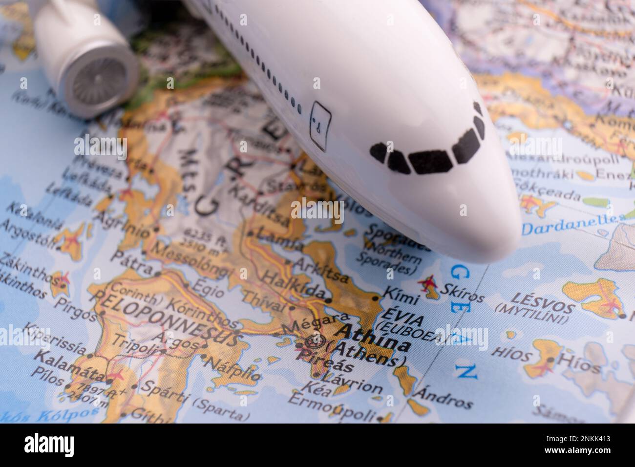 Close up of a miniature passenger plane on a colorful map showing ...