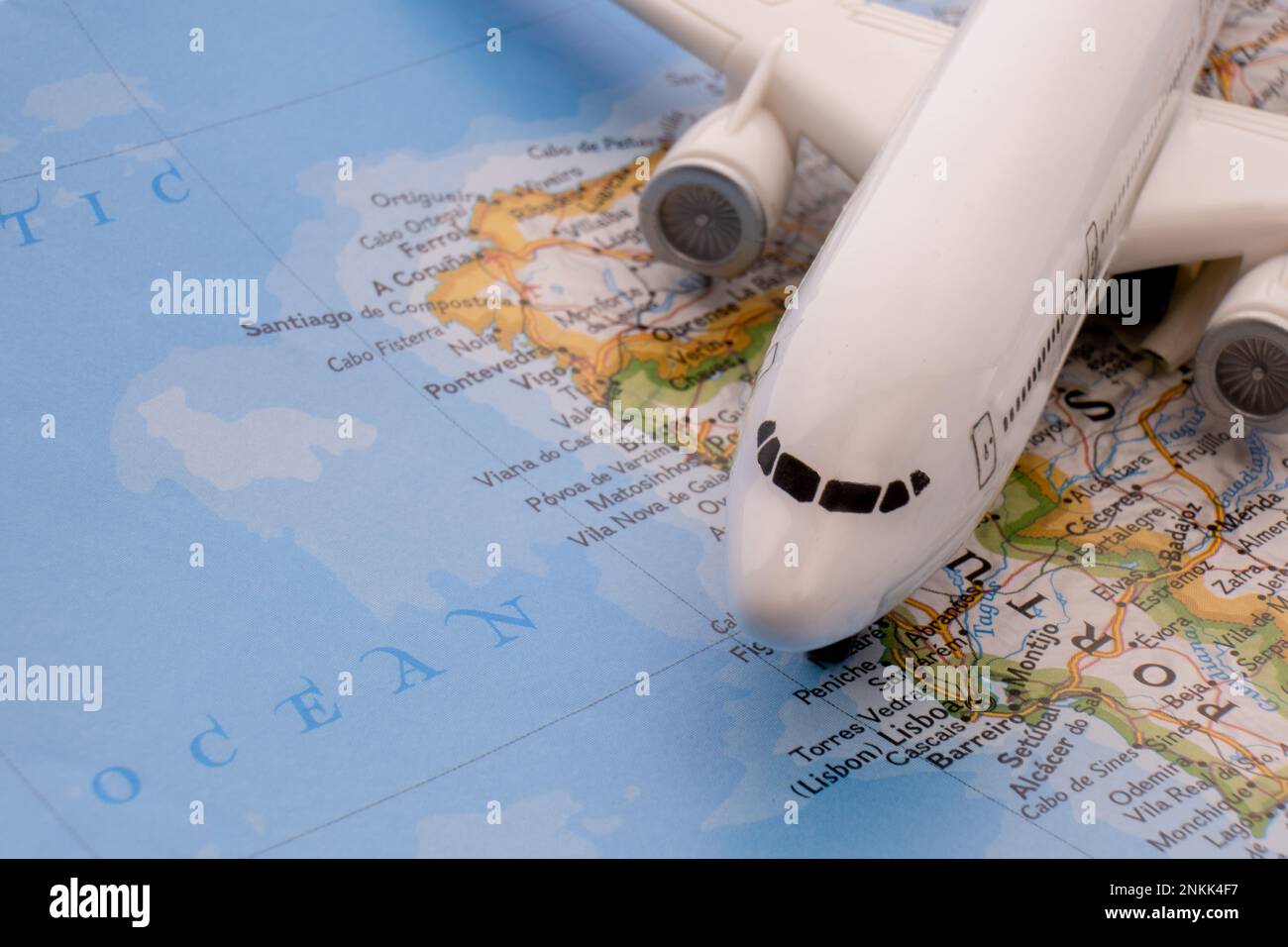 Close up of a miniature passenger plane on a colorful map highlighting ...