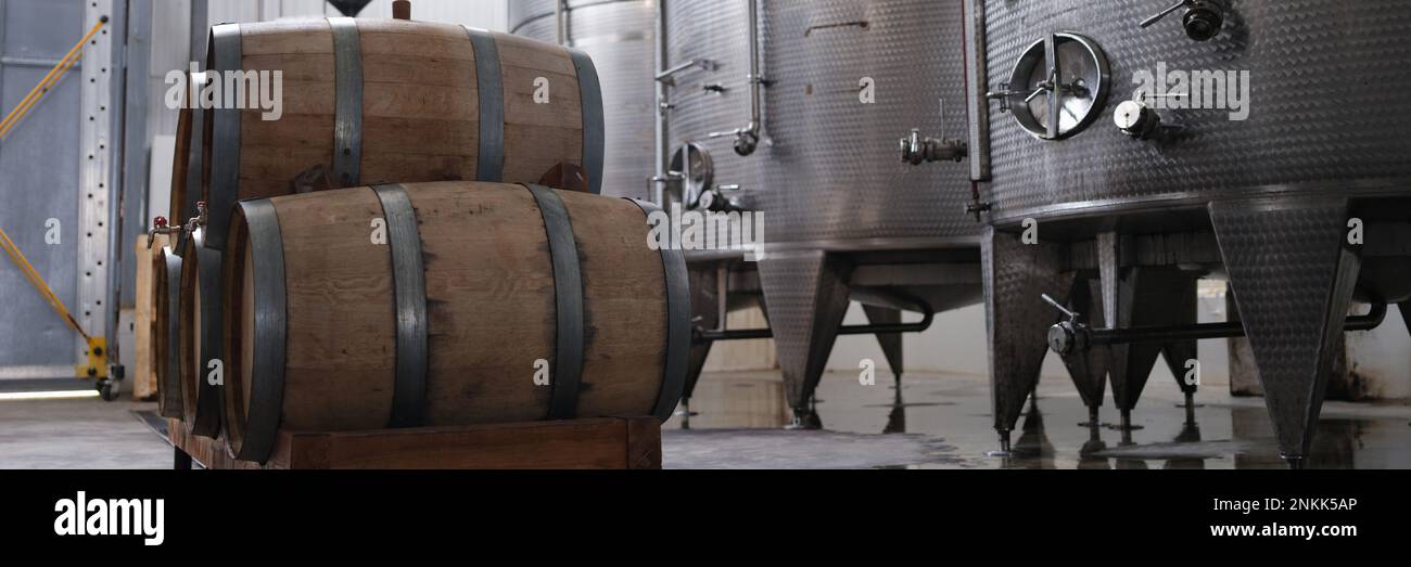 Huge tanks in wine cellars and wooden barrels of wine or alcohol Stock ...