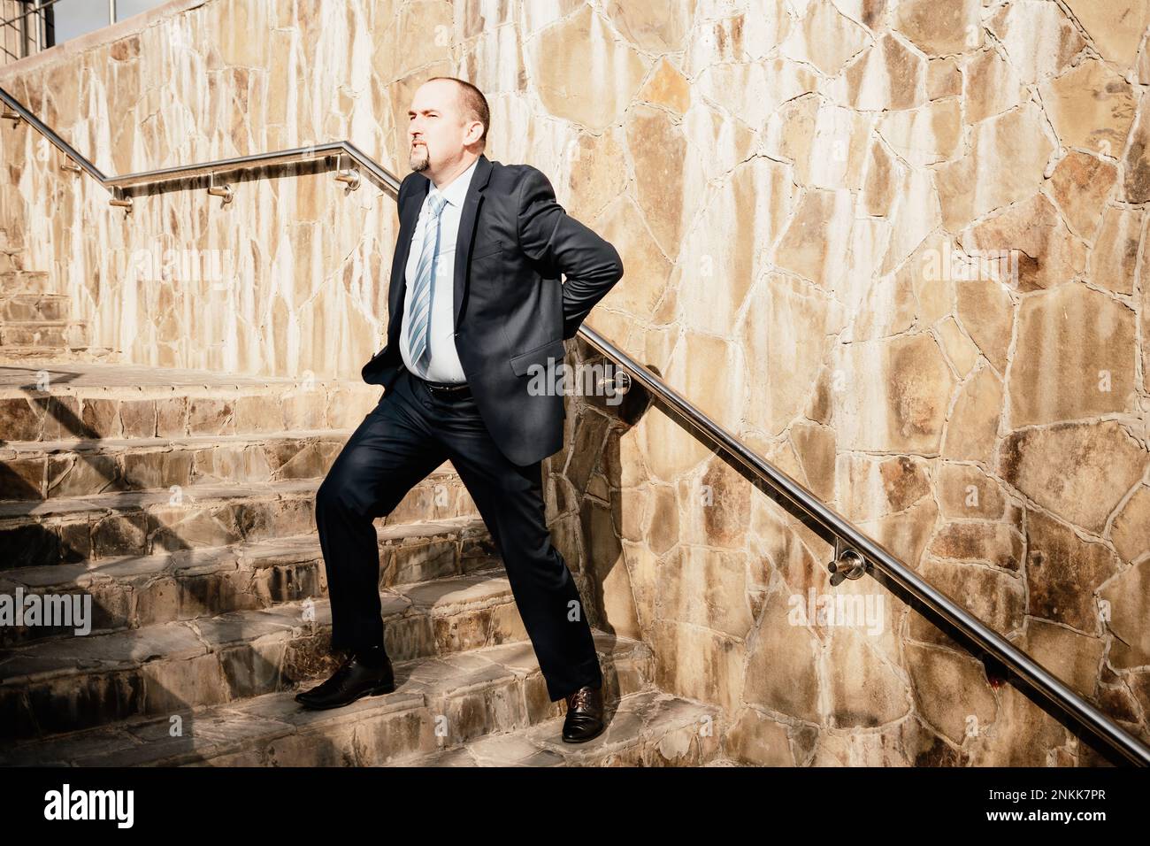 Portrait of a senior professional man in a suit with various problems ...