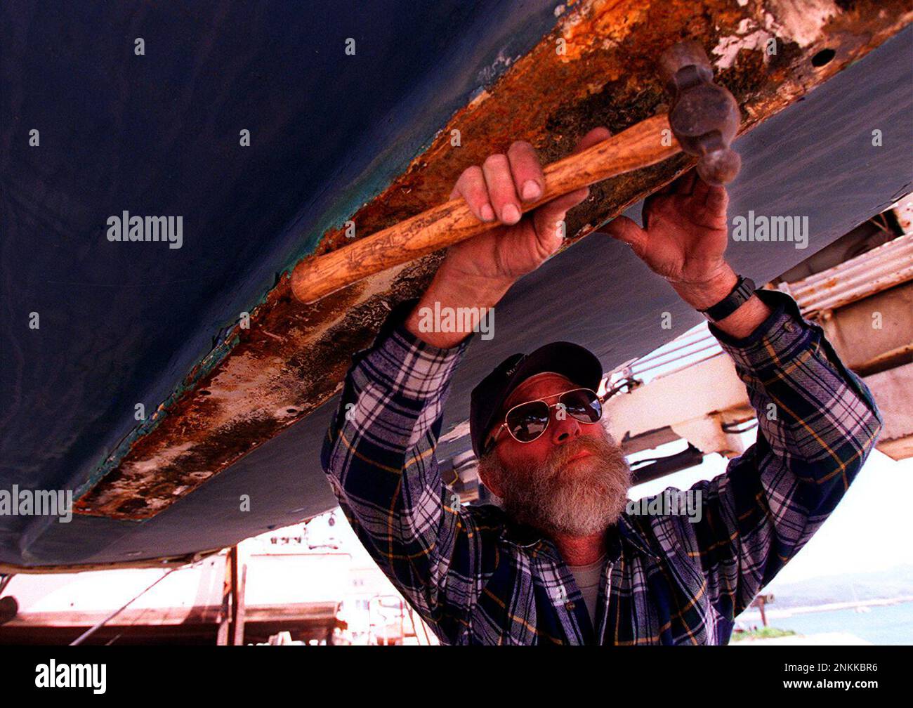 PRINCETON 5/C/15APR98/PF/MJM Ray Farnow checks the damaged hull of a ...