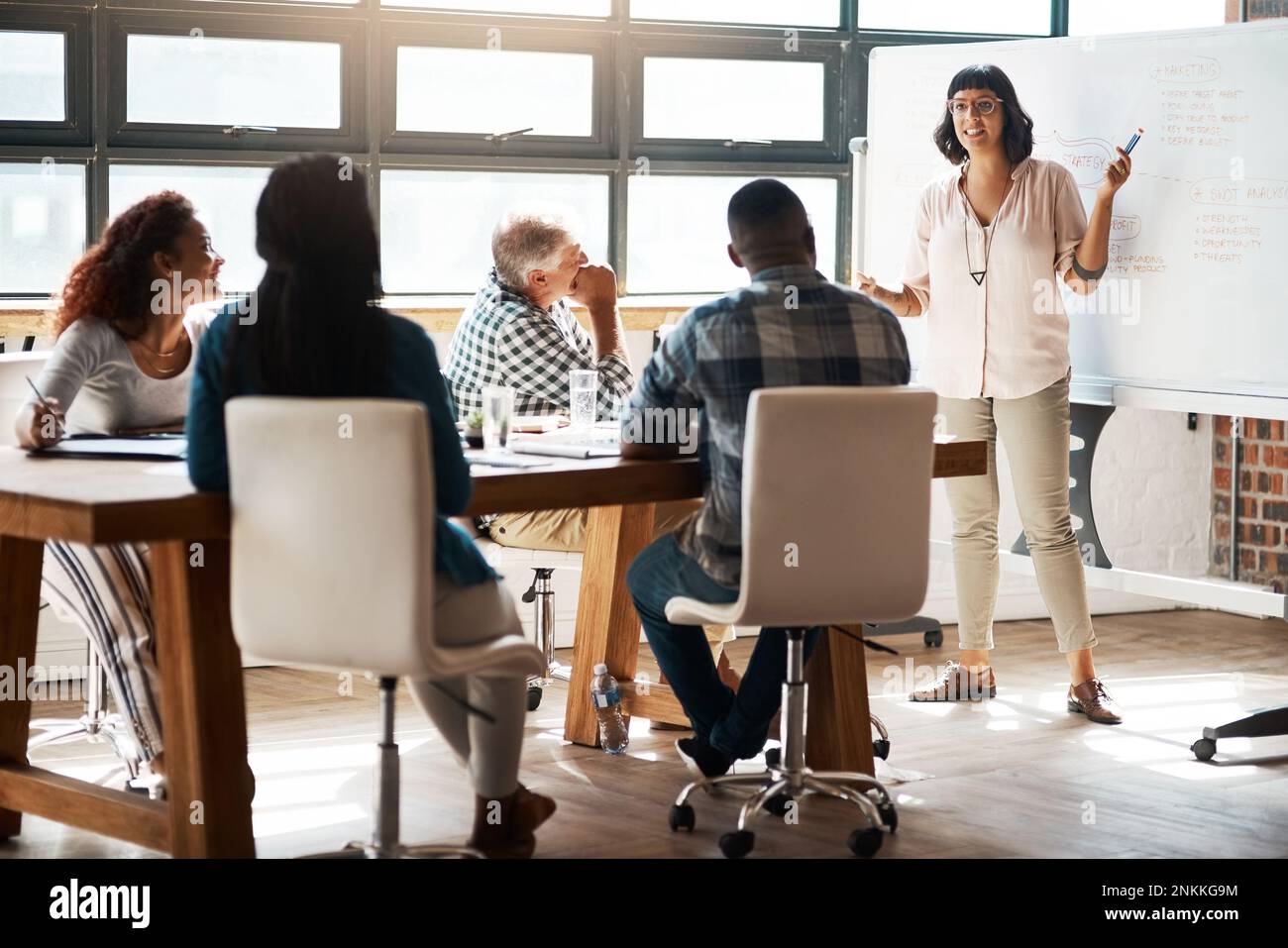 The marketing department making things happen. a businesswoman giving a ...