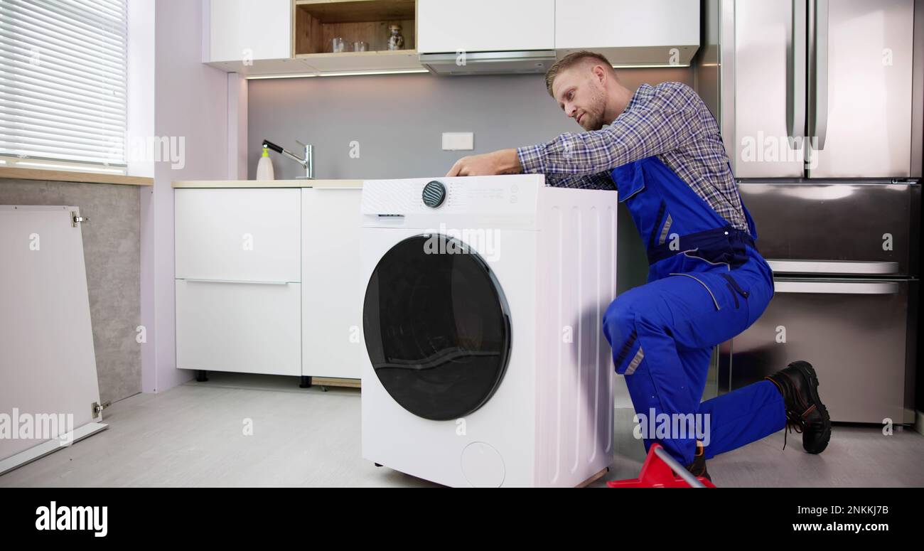Washing Machine Repair Problem. Man Fixing Appliance Stock Photo - Alamy
