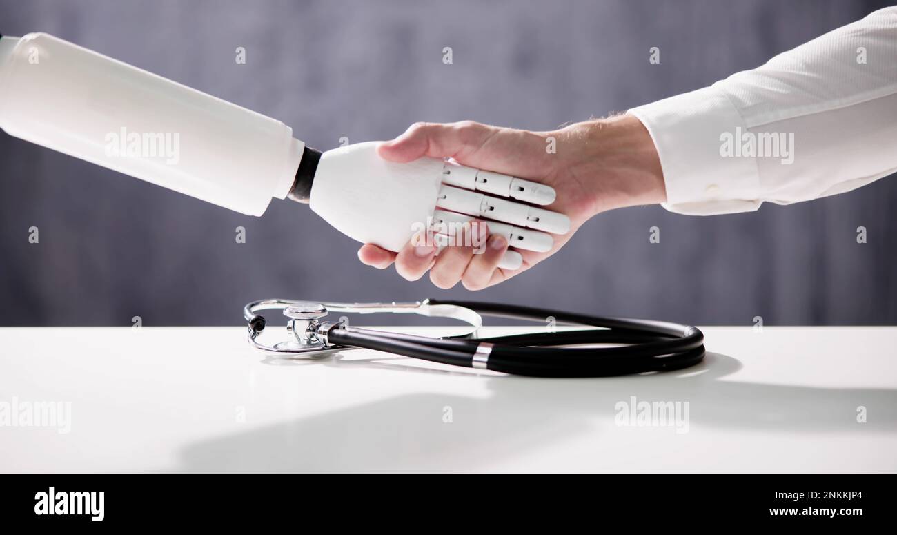 Doctor And Robot Shaking Hands Over Stethoscope Stock Photo - Alamy
