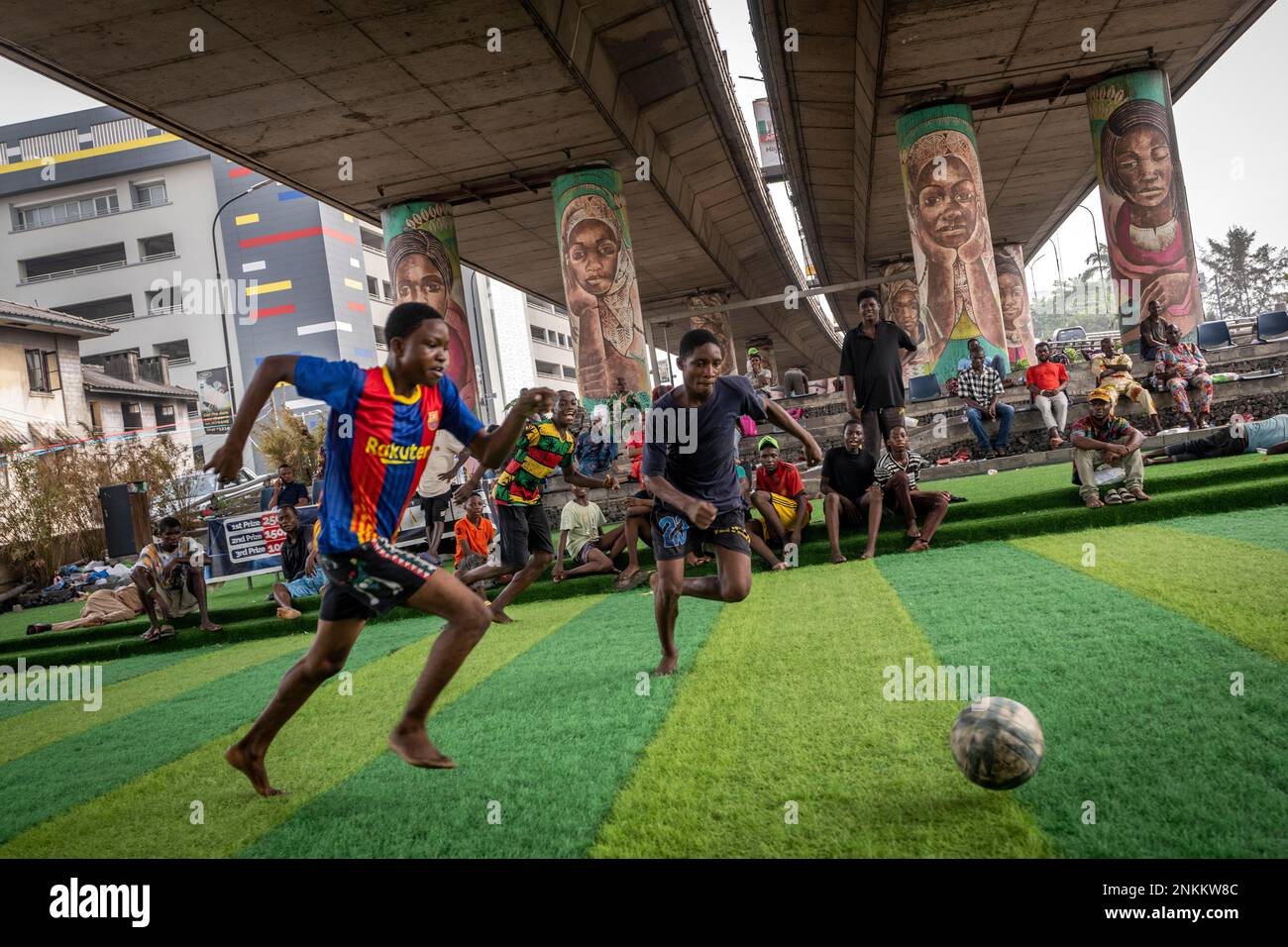 Youth play football underneath a highway bridge on Ikoyi Island, Lagos ...