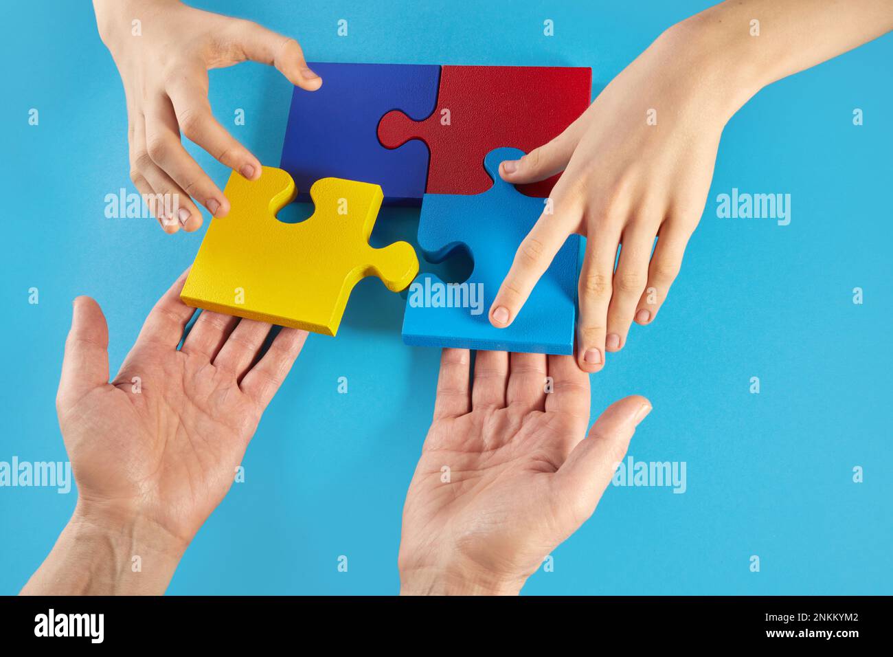 Father and autistic son hands holding jigsaw puzzle shape. World Autism ...