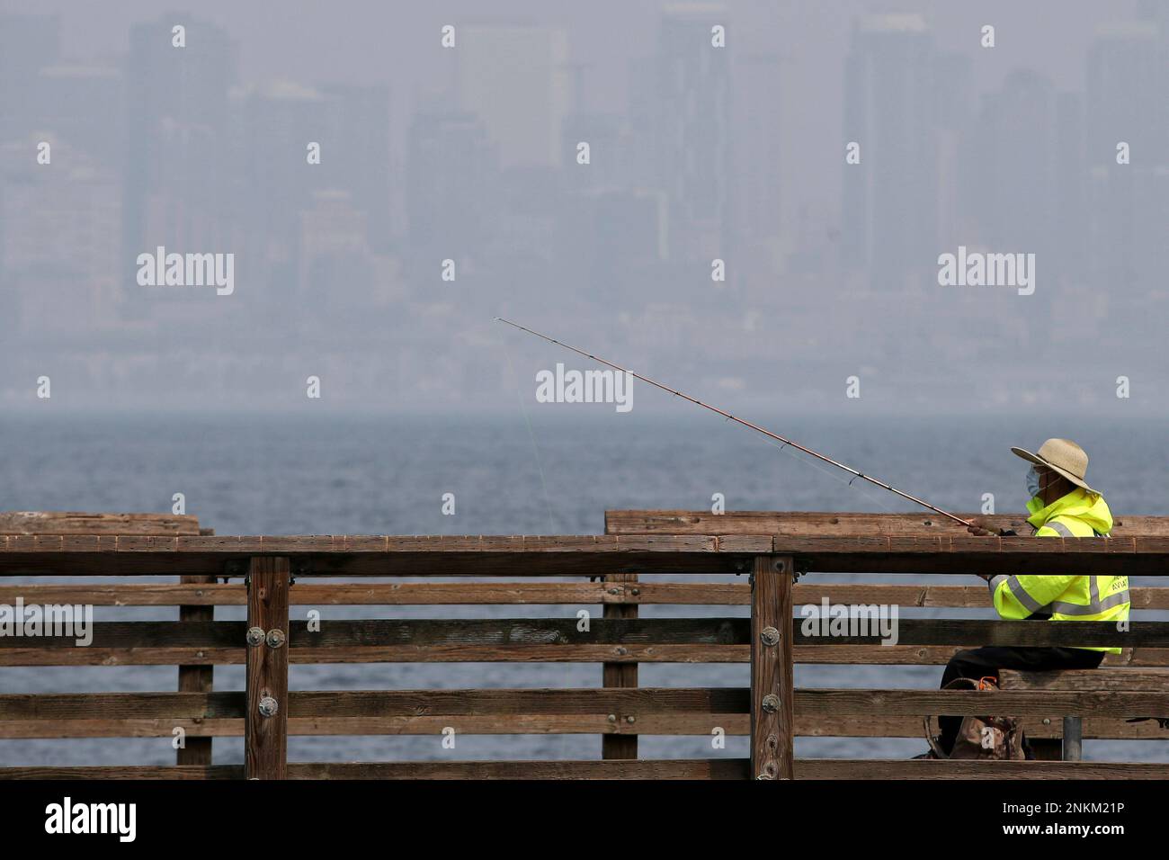 Fishermen wear face masks along Seacrest Dock as wildfire smoke ...