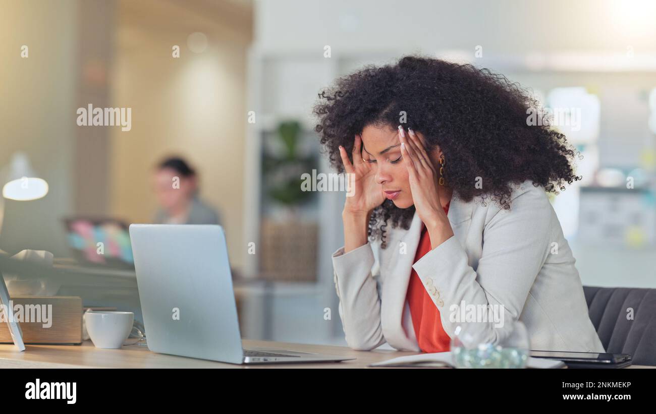 Stressed software analyst typing on laptop with headache and making a ...