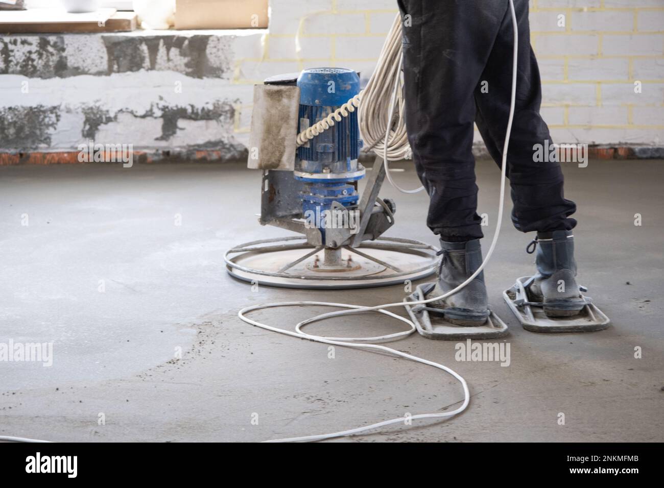 Ramming and grinding of semi-dry floor screed by a machine with a ...