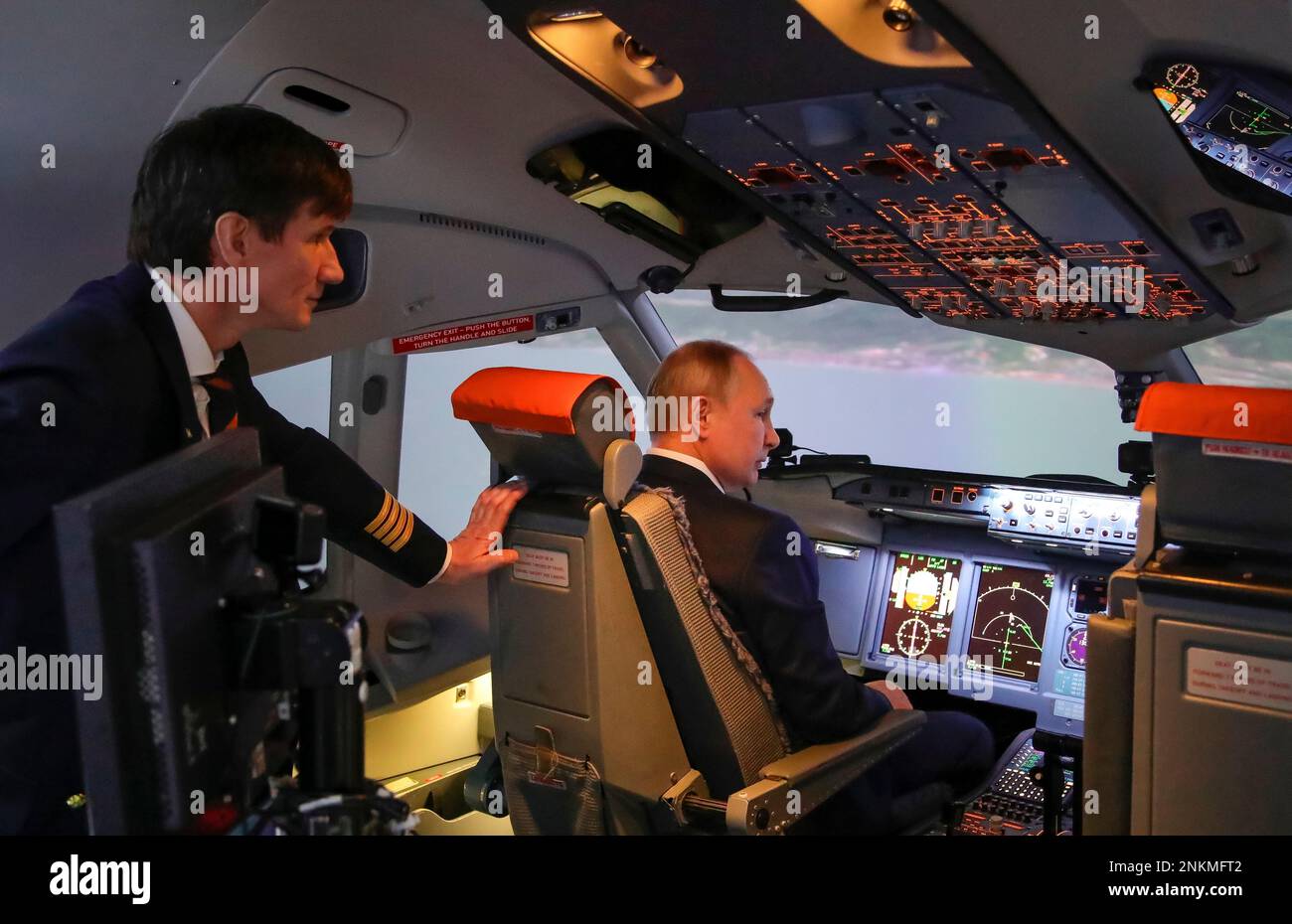 Russian President Vladimir Putin sits in the cockpit of an airplane ...