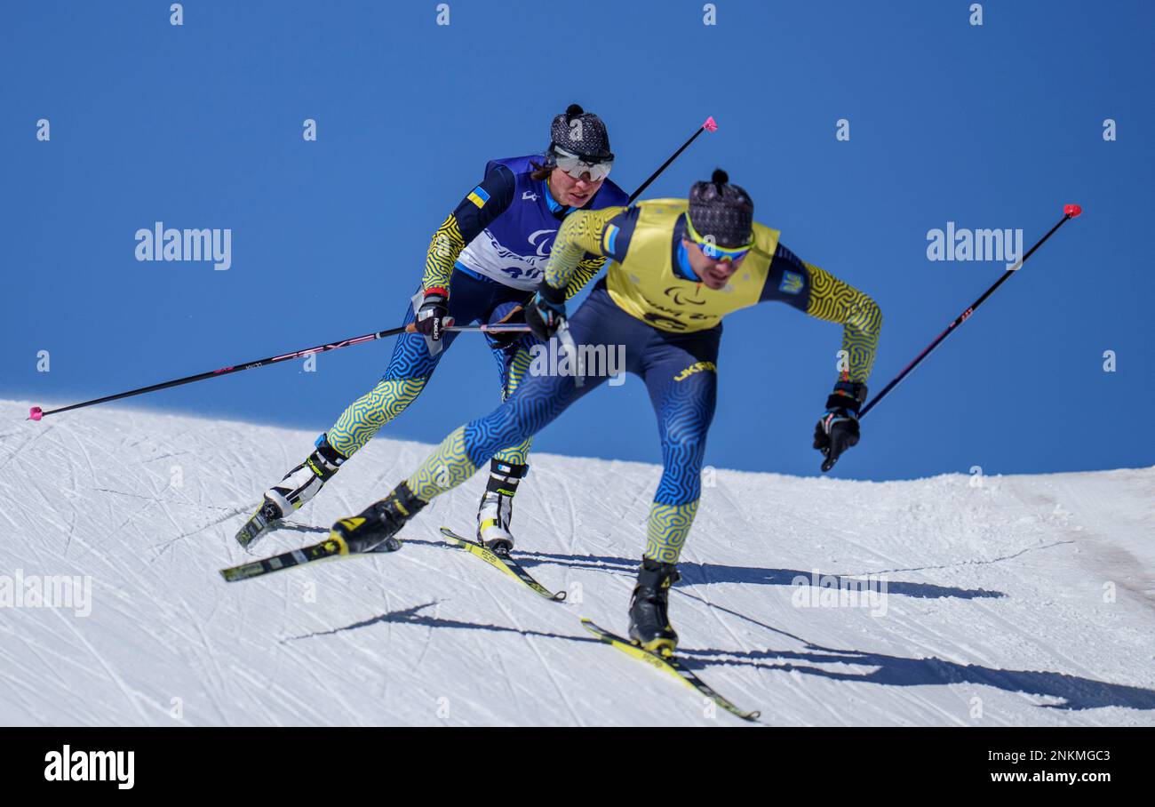 Gold medalist Oksana Shyshkova of the Ukraine follows behind her guide ...