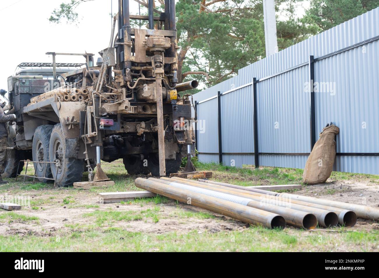 Drilling rig on zil car are drilling artesian well for water in ground ...
