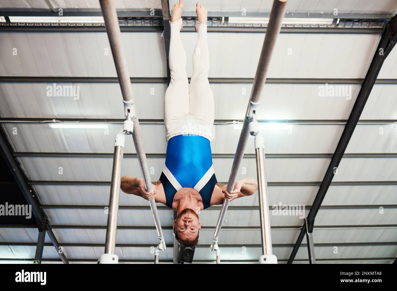 Man, gymnast and upside down on poles in fitness for practice, training ...