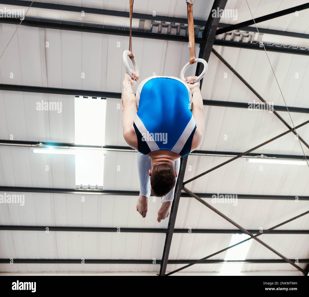 Man, acrobat and gymnast turning on rings in fitness for practice ...