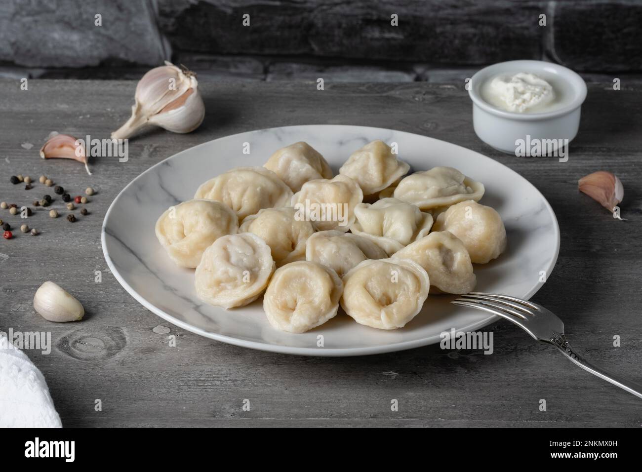 Traditional russian pelmeni, ravioli, dumplings with meat on a wooden ...